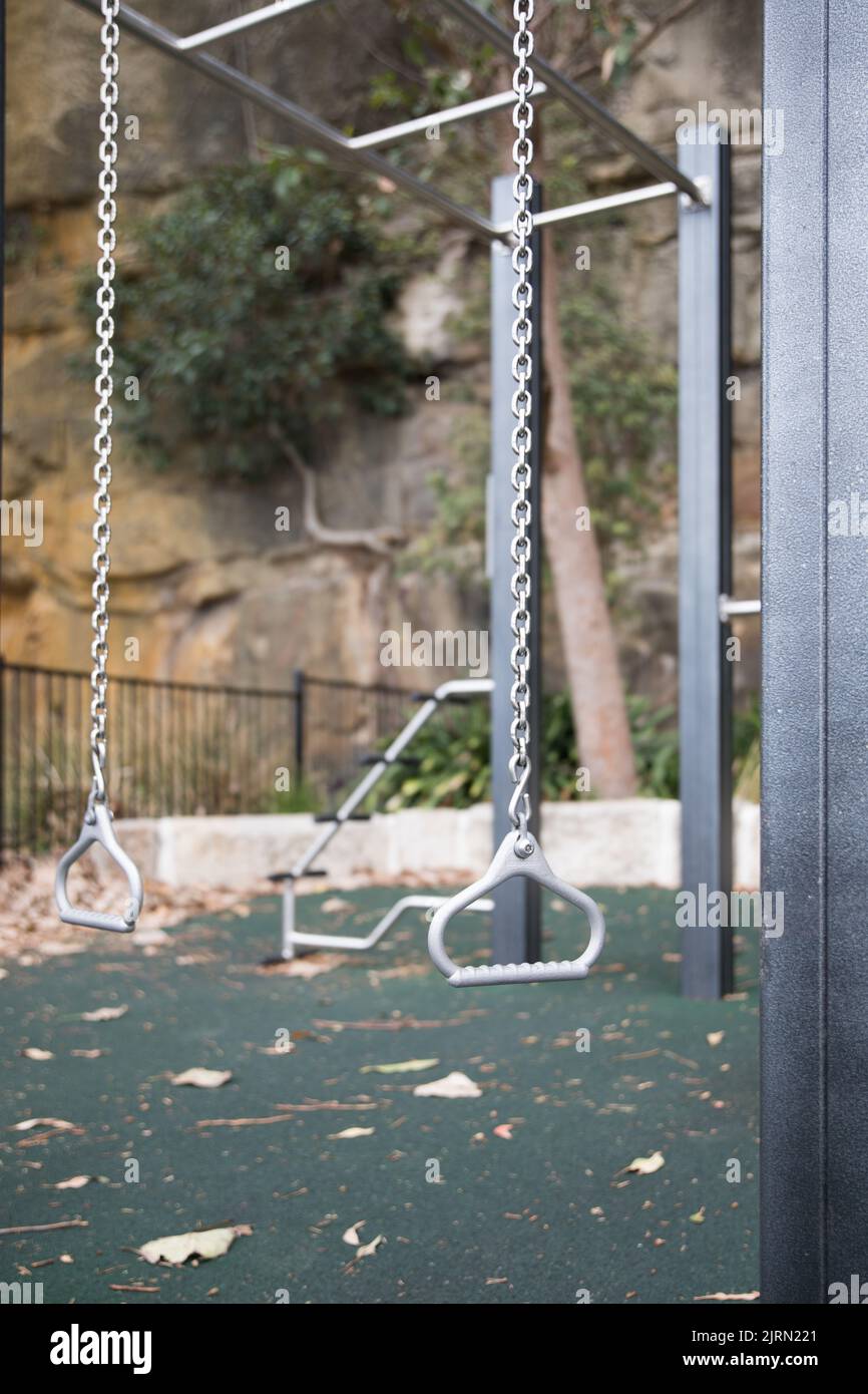 A vertical shot of metal rings on chains for street work out and ...