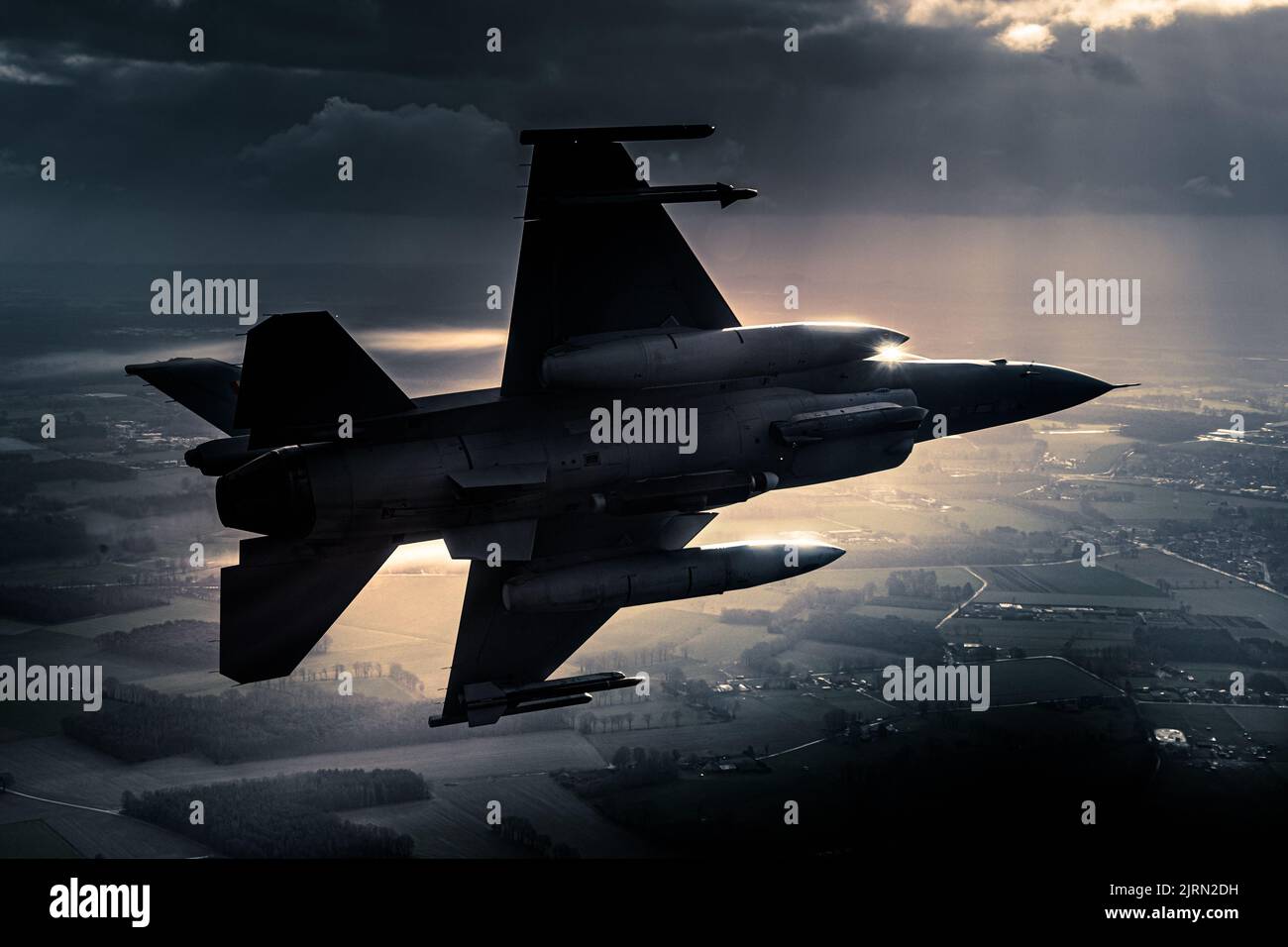 An F-16 Falcon multirole fighter aircraft maneuvering in the sky during ...