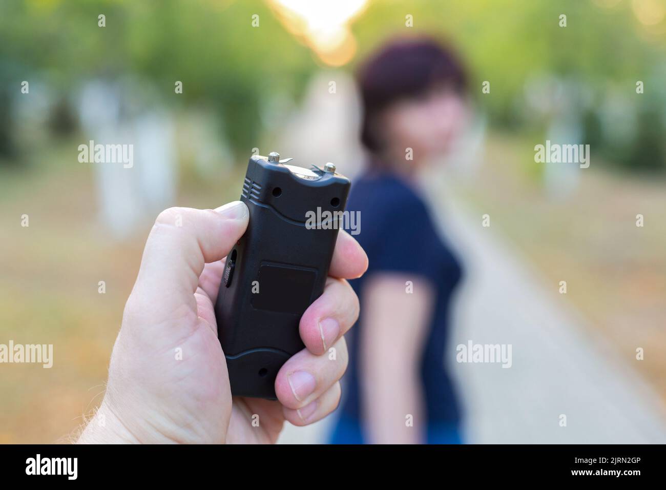 Hand with electric shocker criminal catches up with the woman for the ...