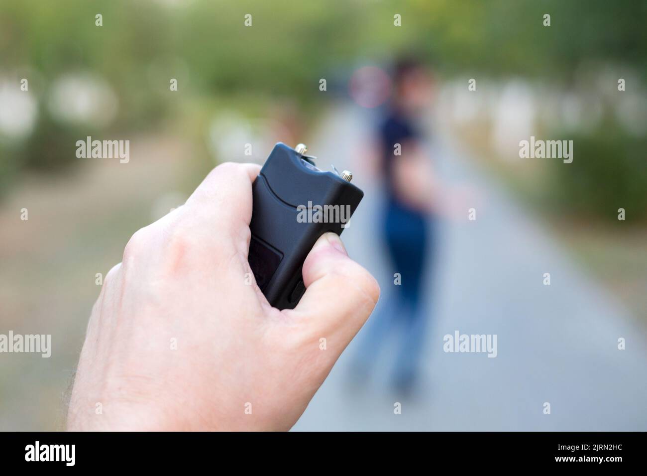 Hand with electric shocker, the criminal catches up with woman for ...