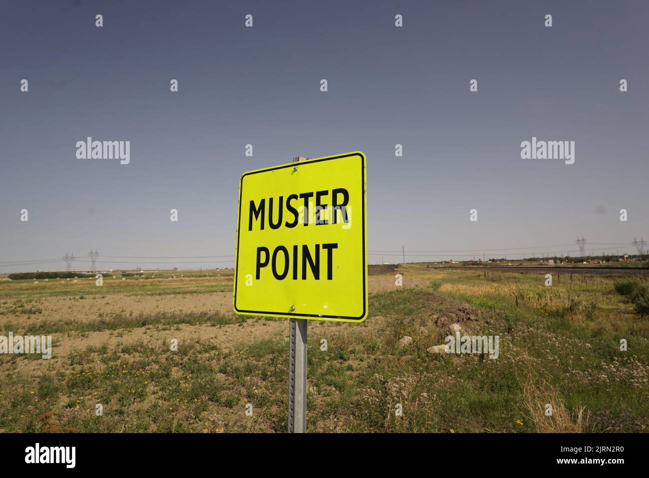 A muster point sign in front of an empty desolate field Stock Photo - Alamy