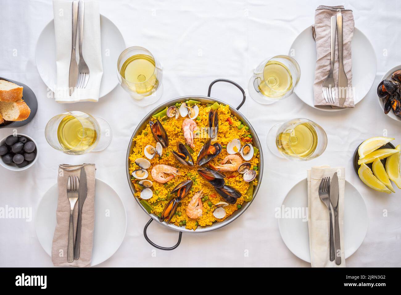Table setting for friends meeting. Spanish paella for food friends. Top ...