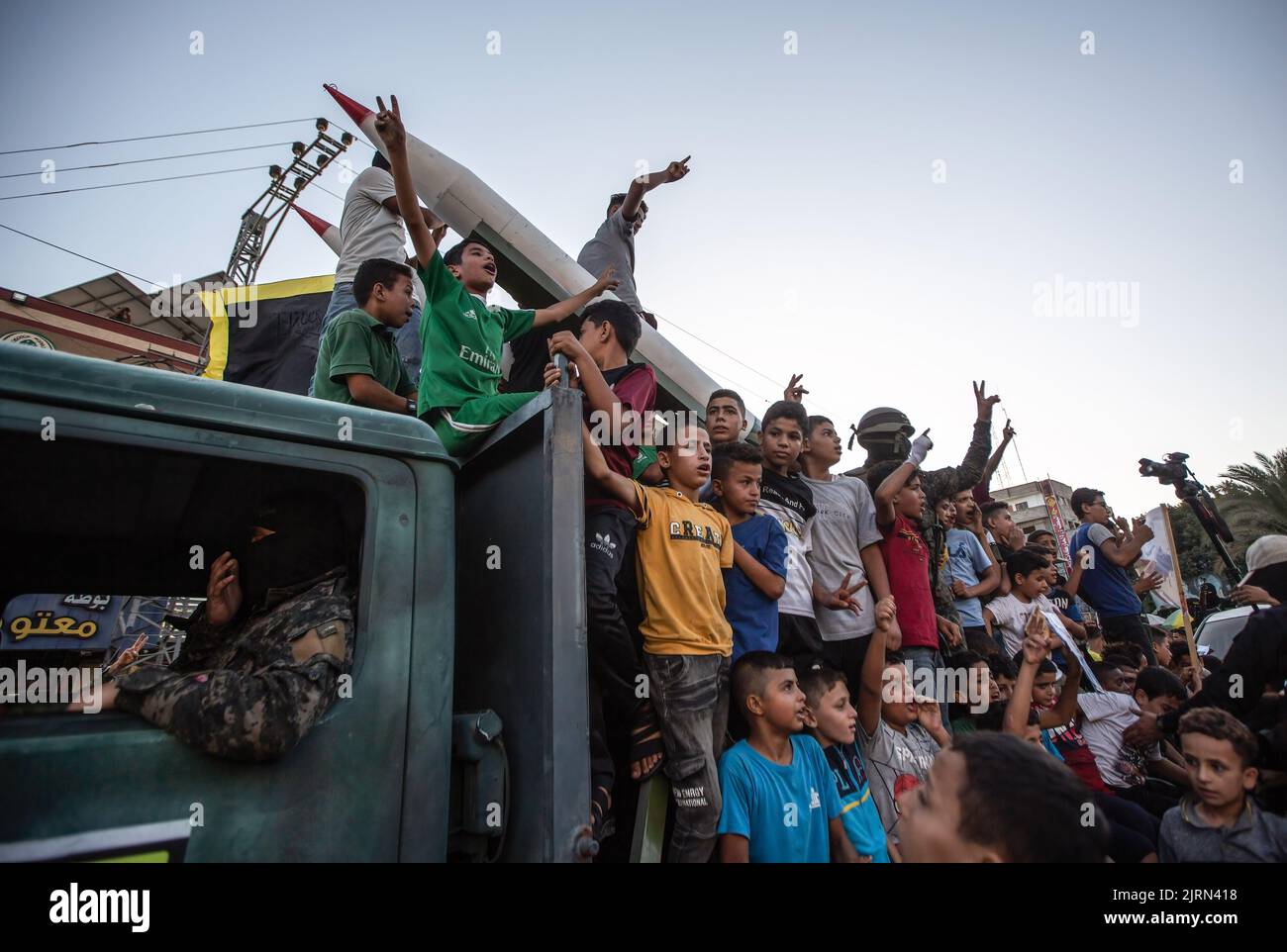 Palestinian children aboard a truck carrying missiles made by Al-Quds ...