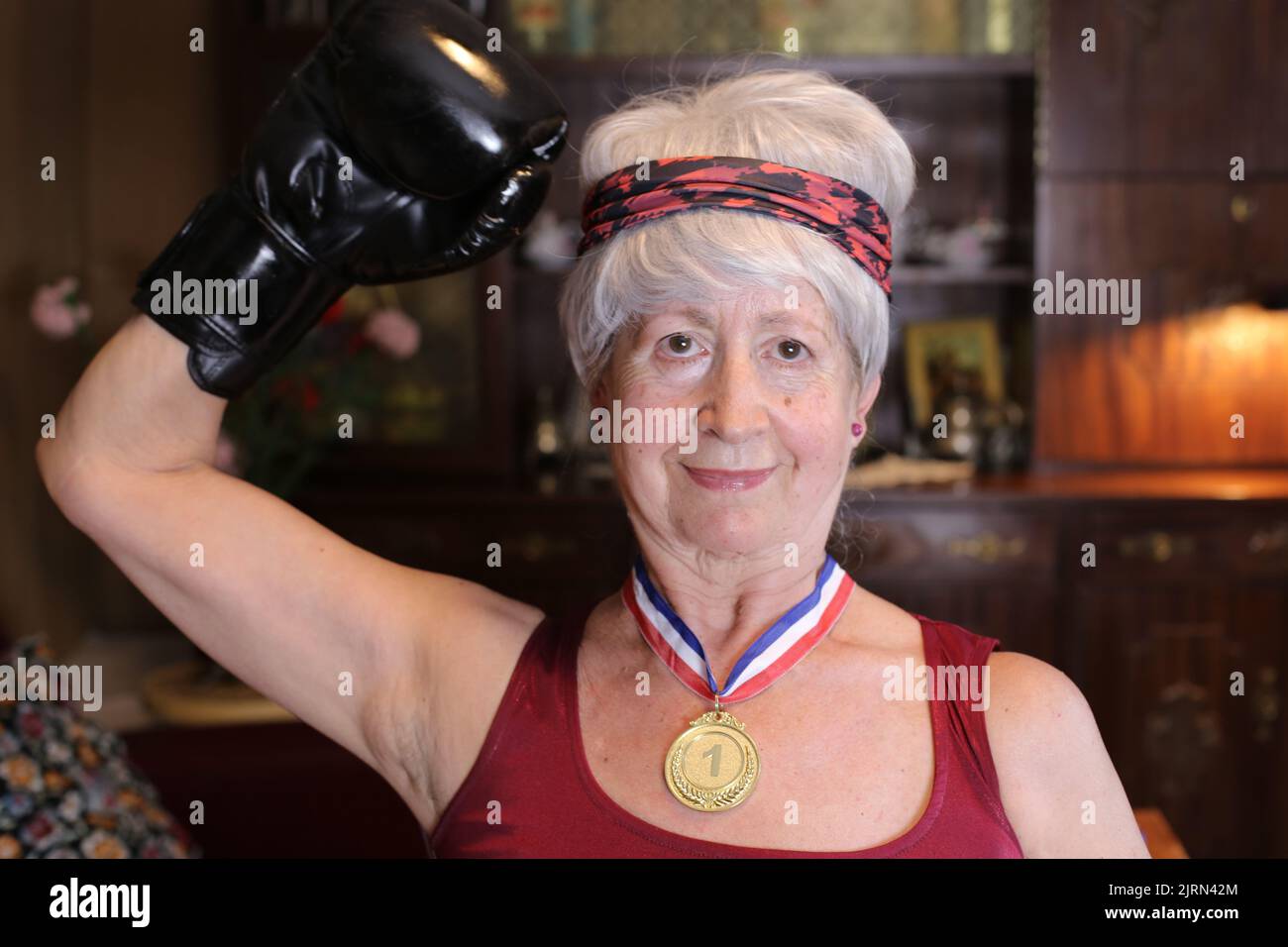 Proud female winner with boxing gloves Stock Photo - Alamy