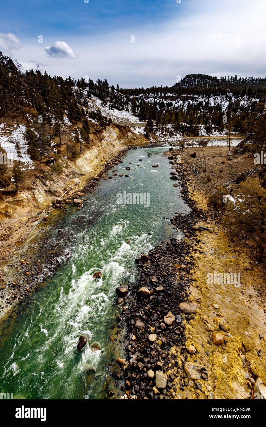 A vertical shot of a flowing river in Yellowstone National Park Stock ...