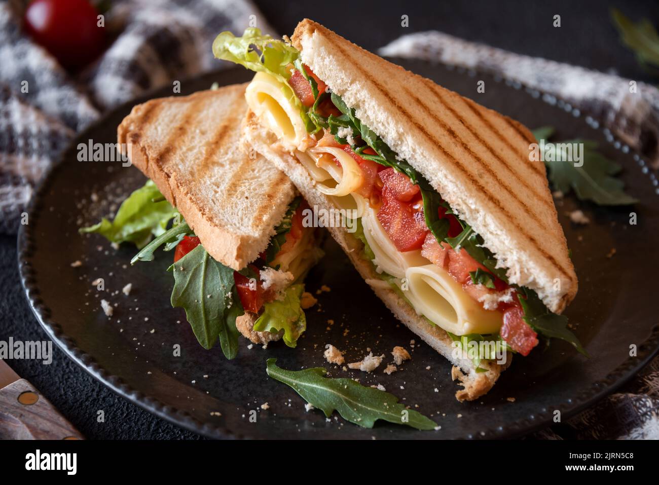 Toasted bread sandwich with cheese, ham, tomatoes and vegetables Stock ...