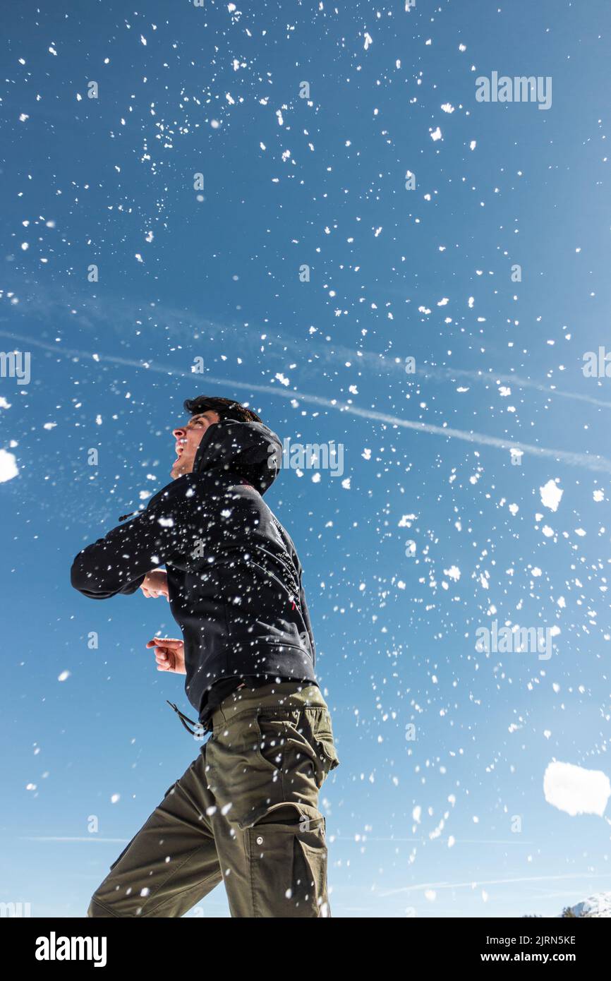 Caucasian handsome man fighting in the middle of a snowy place. He is ...