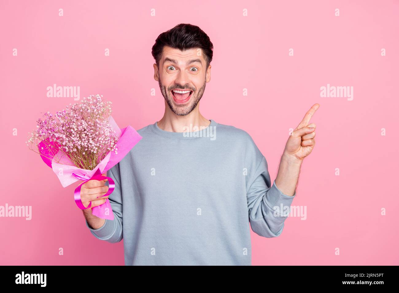 Photo of funky guy hand hold flowers indicate finger empty space ...