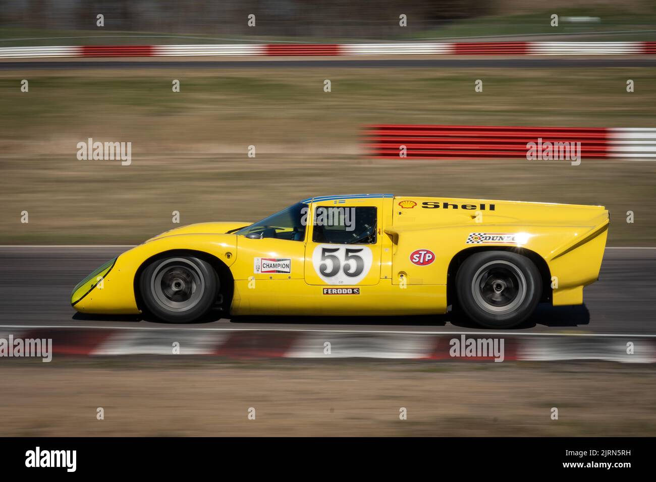 A yellow race car at the track Lola Stock Photo - Alamy