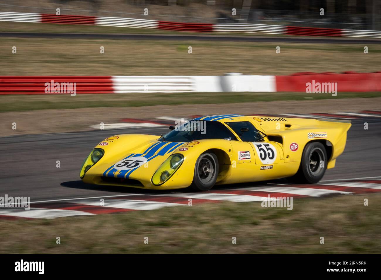 A yellow race car at the track Lola Stock Photo - Alamy