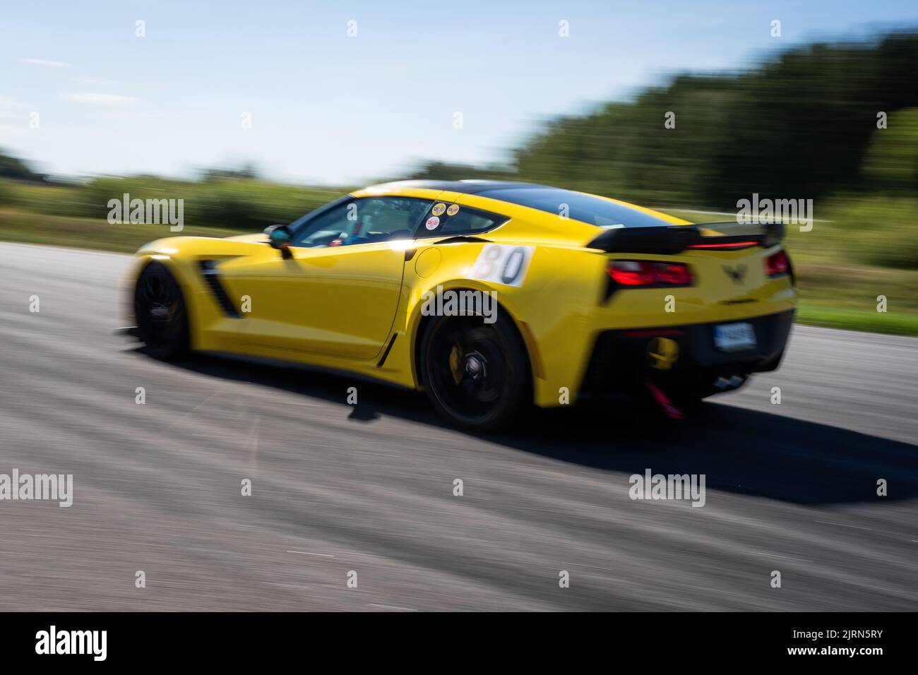A yellow race car at the track chevrolet Stock Photo - Alamy