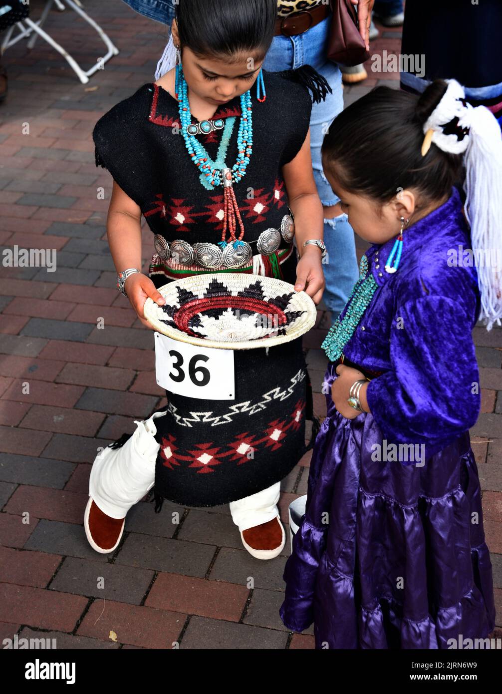 Two young Navajo Native American girls prepare to compete in the Native ...