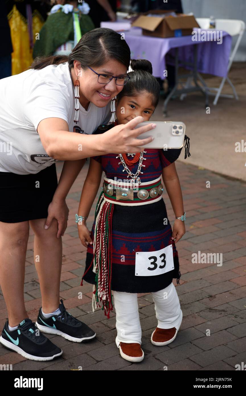 A Native American mother (Navajo) takes a photograph of her daughter at ...