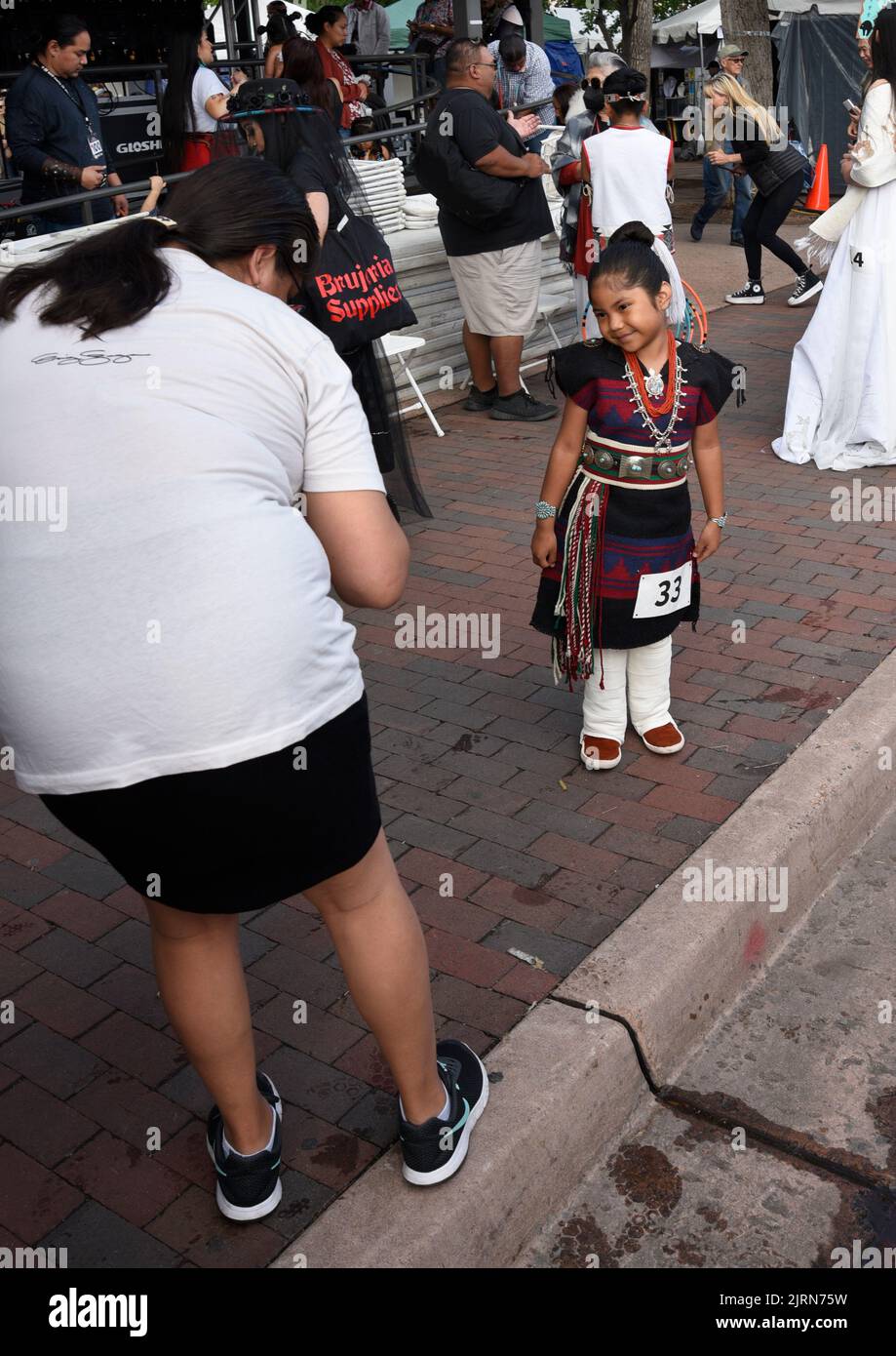 A Native American mother (Navajo) takes a photograph of her daughter at ...