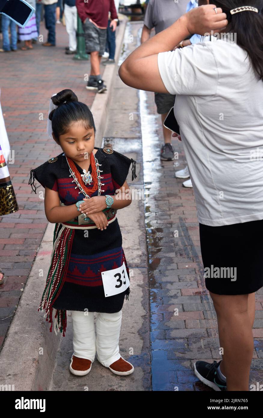 A Native American mother (Navajo) takes a photograph of her daughter at ...