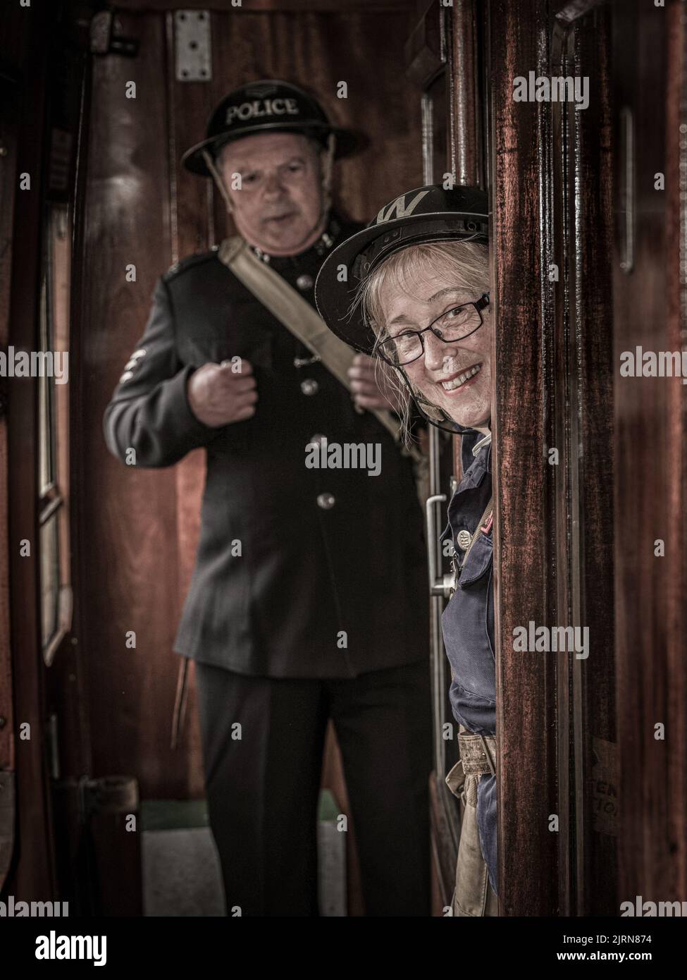 A WW2 warden and police officer in period train carriage Stock Photo ...