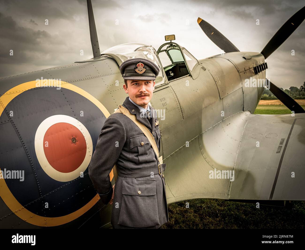 A WW2 Flying officer in front of Supermarine spitfire from the battle ...