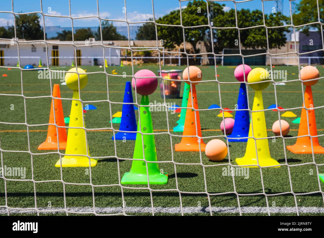 In summer the children play sports using colorful cones and materials ...