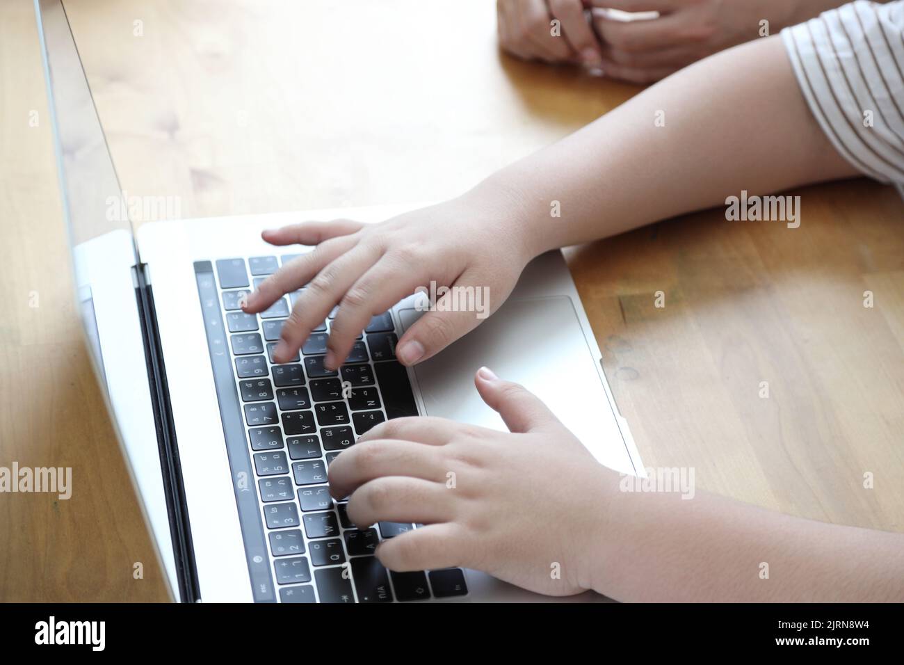 Asian kid using laptop hi-res stock photography and images - Alamy