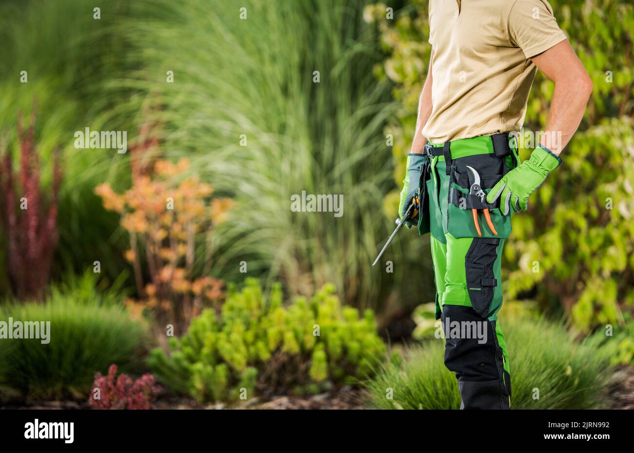 Professional Garden Worker with His Tools Staying Inside Beautiful ...