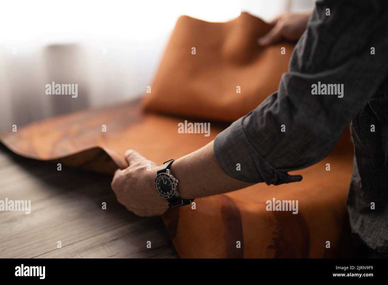 A human hands holding brown leather Stock Photo - Alamy