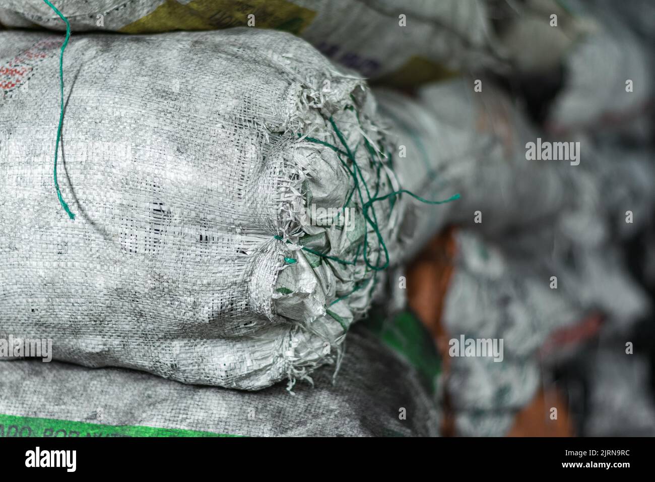 detailed view of white sacks full of material and products inside a ...