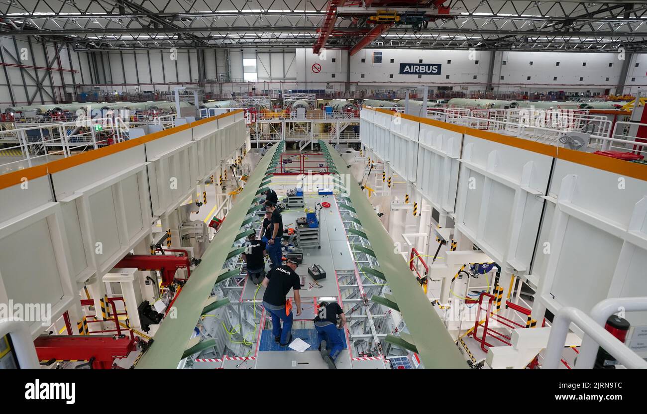 24 August 2022, Hamburg: Airbus employees work on the A320 fuselages in hangar 260 on the Airbus ...