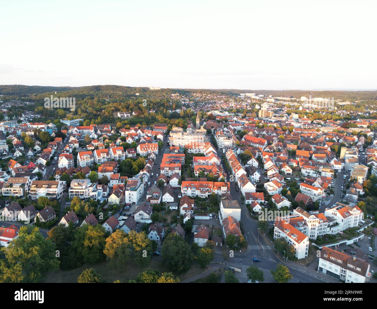 A drone view of a city full of similar buildings and trees with big ...