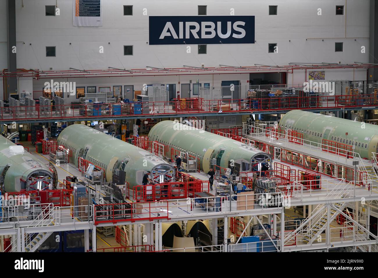 24 August 2022, Hamburg: Airbus employees work on the A320 fuselages in ...