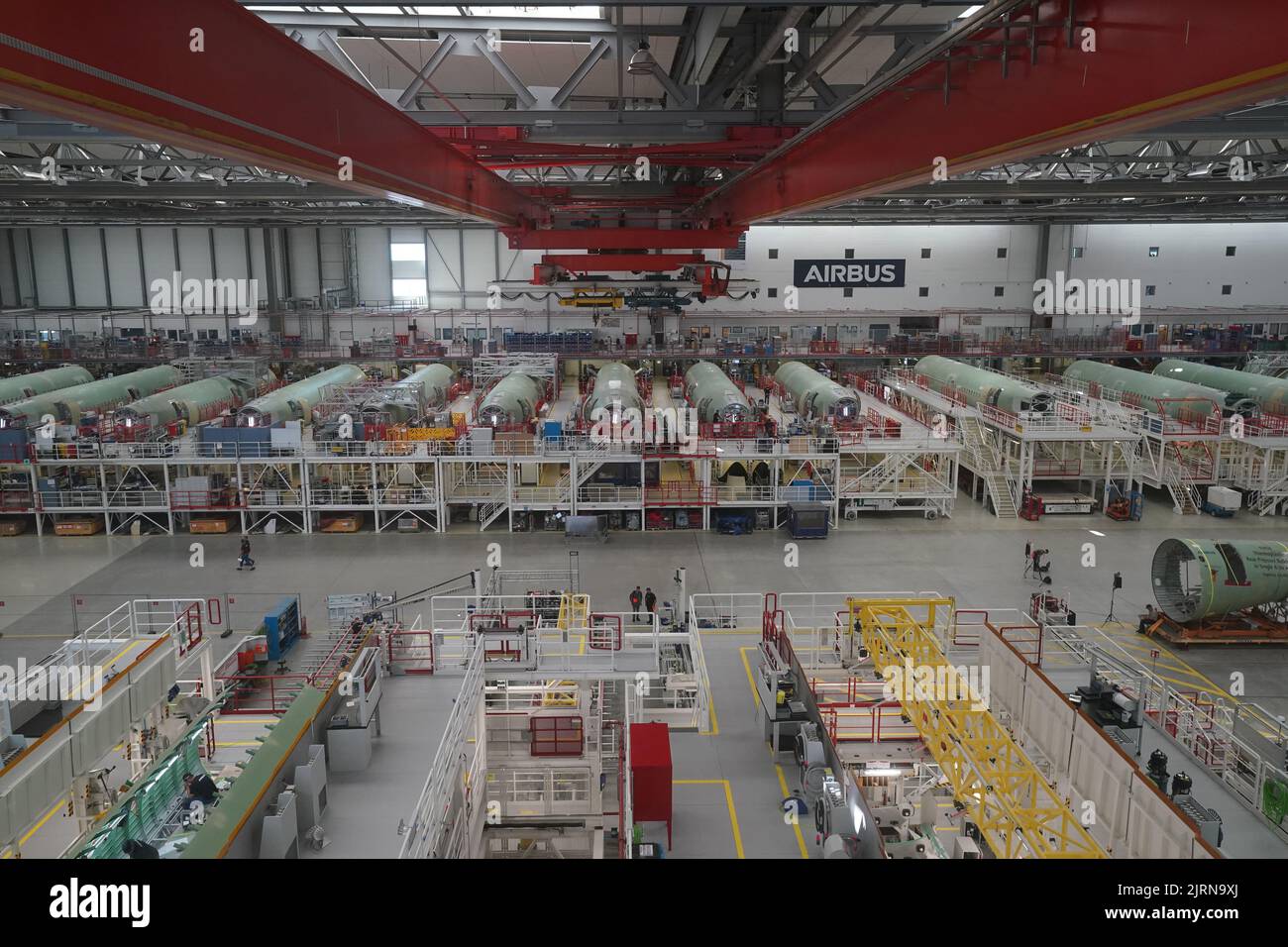 24 August 2022, Hamburg: Airbus employees work on the A320 fuselages in ...