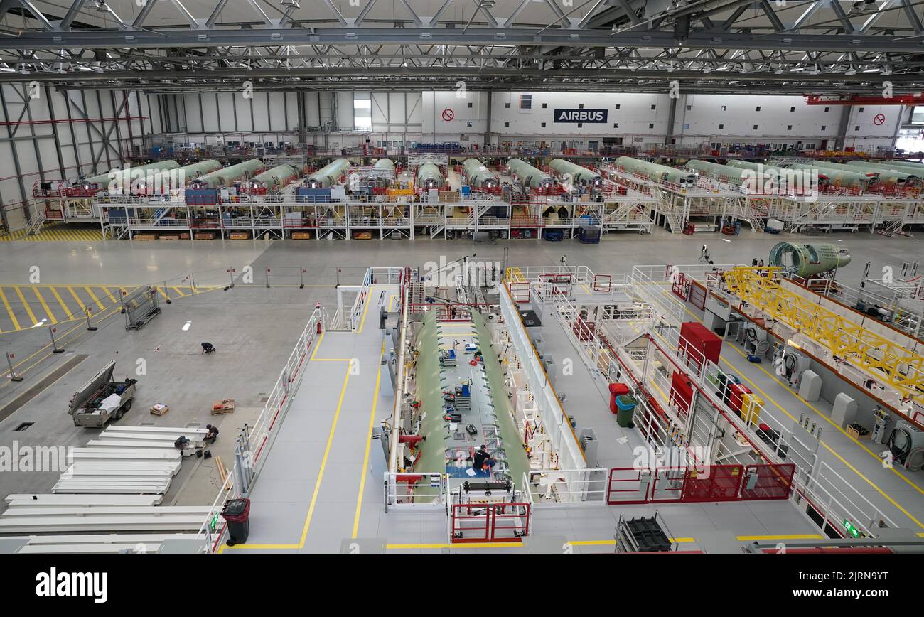 24 August 2022, Hamburg: Airbus employees work on the A320 fuselages in ...