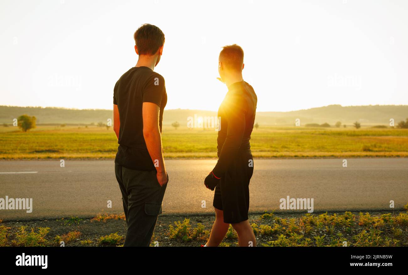 2 friends admire the beautiful view before starting to run on the field ...