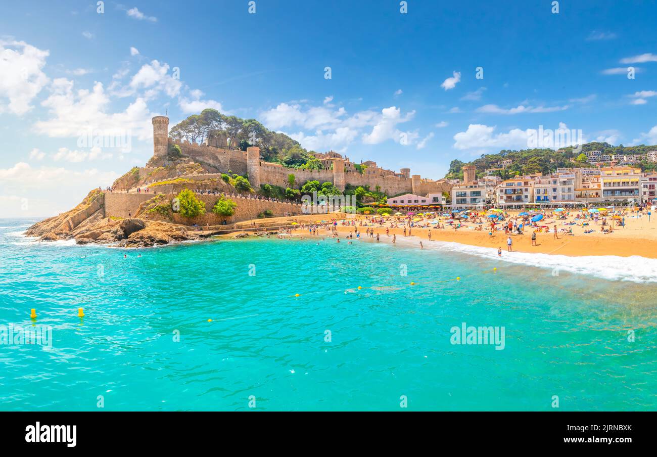 Panoramic view of the 12th century castle, the sandy beach, whitewashed ...