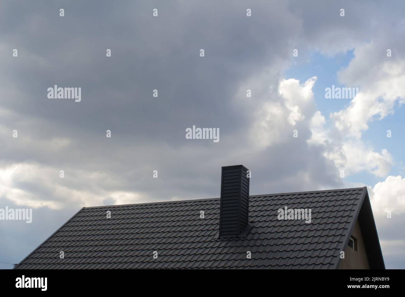 Defocus steel roof on dark sky background. Dark rain clouds above the ...