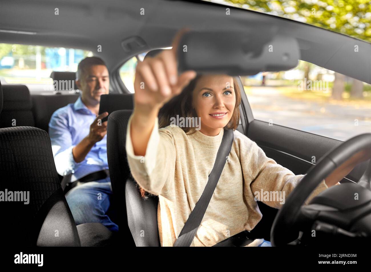 female driver driving car with male passenger Stock Photo - Alamy