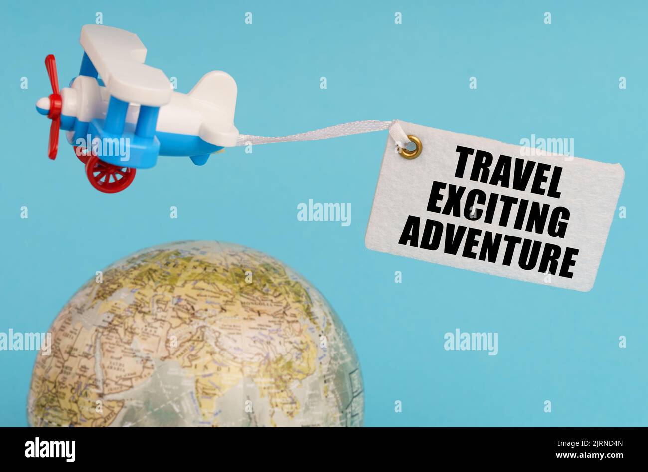 Travel and business concept. On a blue background, a globe and an ...