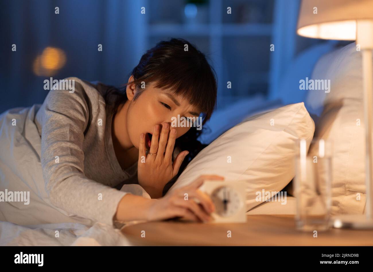 Woman clock bed hi-res stock photography and images - Alamy