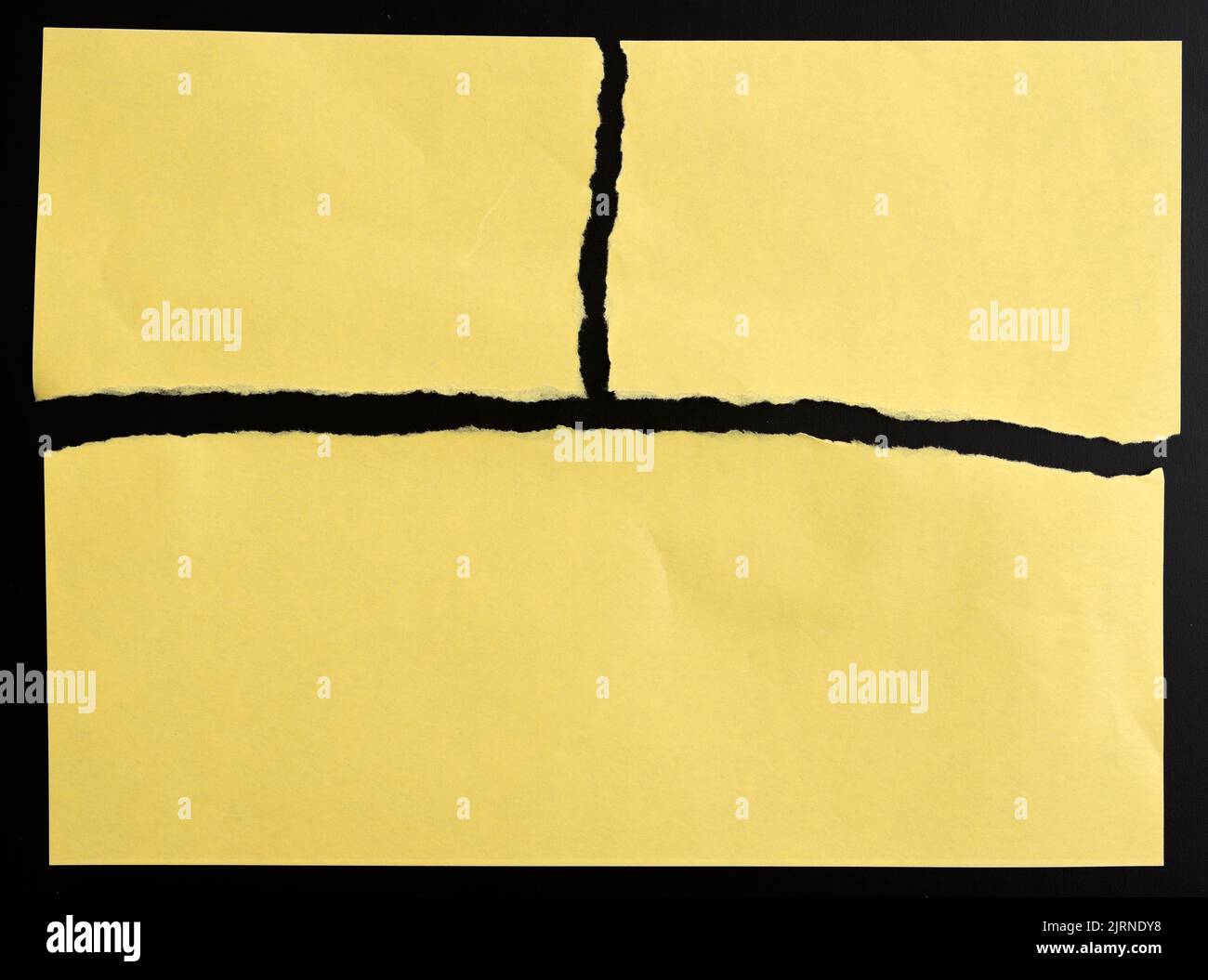 Torn yellow paper on black background Stock Photo - Alamy