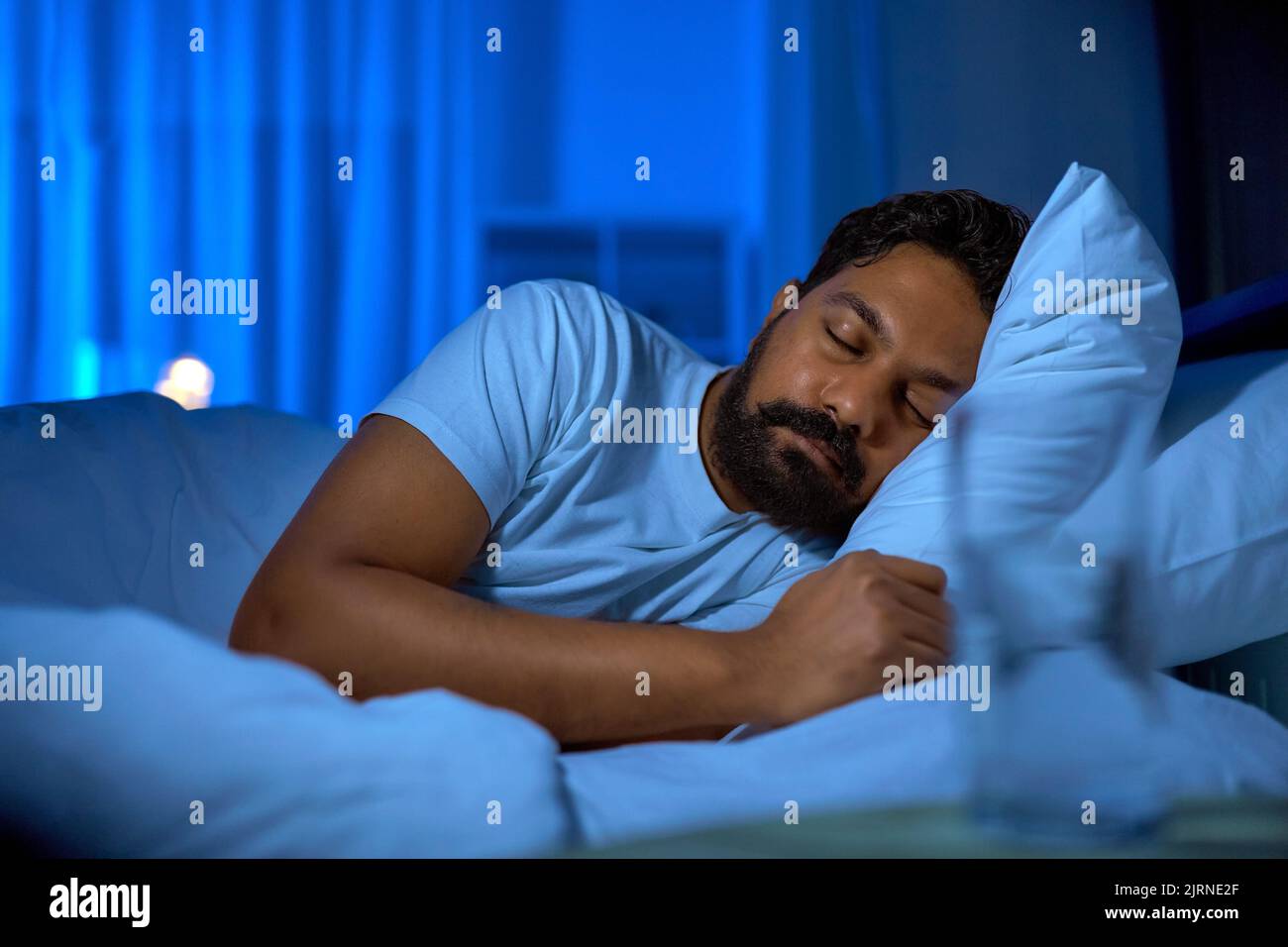 indian man sleeping in bed at home at night Stock Photo - Alamy
