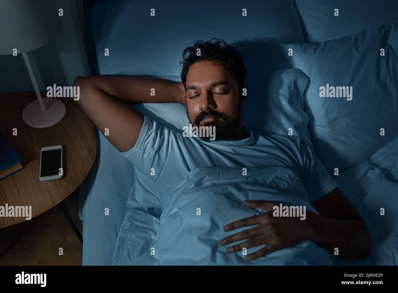 indian man sleeping in bed at home at night Stock Photo - Alamy