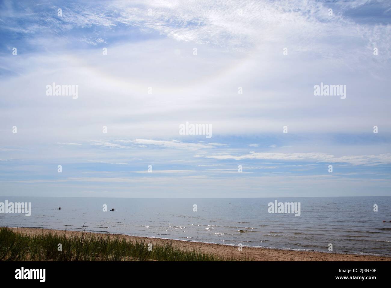 A tranquil scenery of a sandy beach with cloudy sky in the background ...