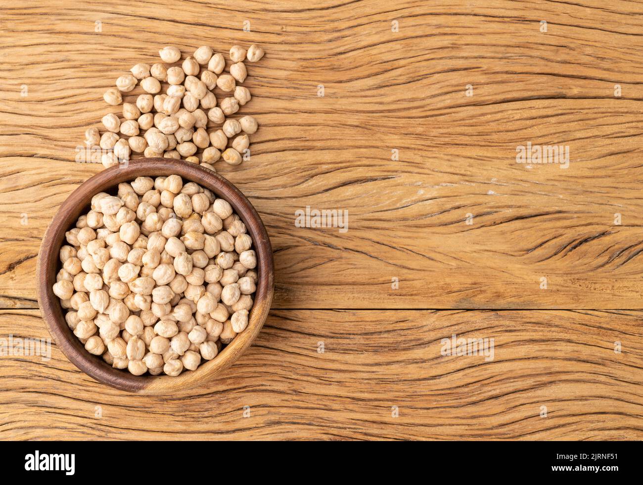 Raw chickpeas on a bowl over wooden table with copy space Stock Photo ...