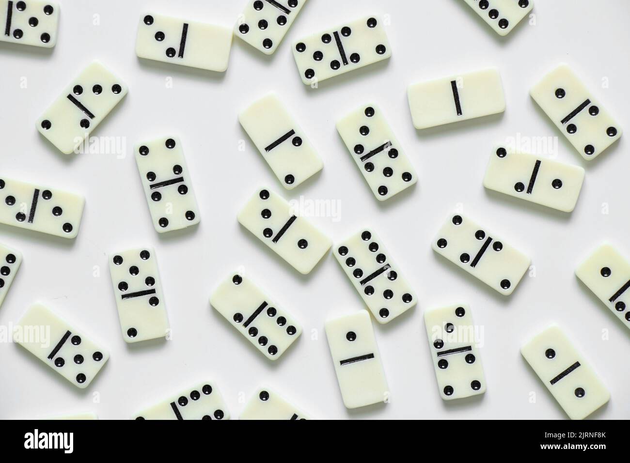 dominoes on a white background close-up, domino effect Stock Photo - Alamy