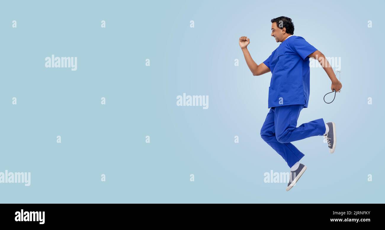 doctor or male nurse with stethoscope jumping Stock Photo - Alamy