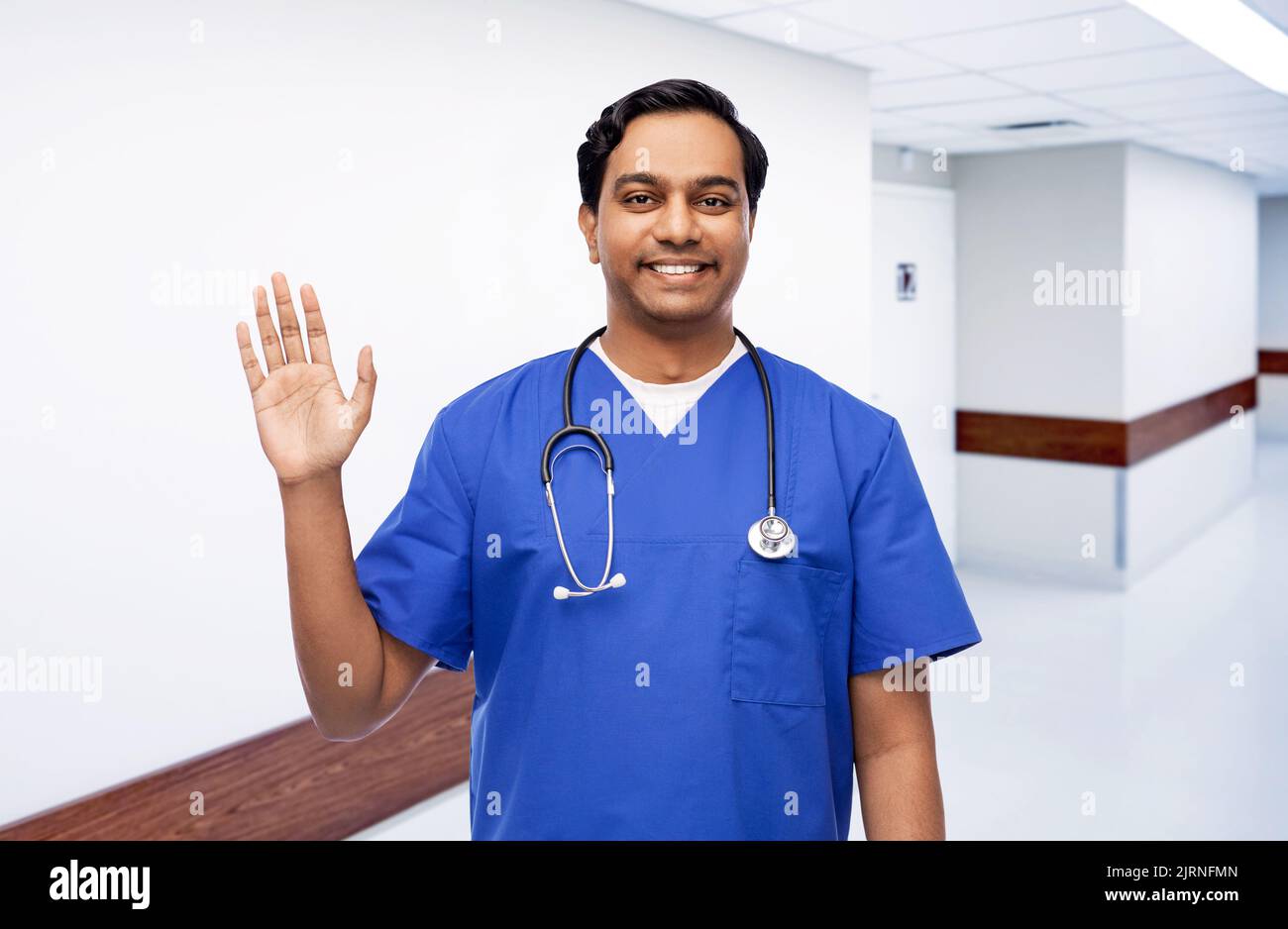 doctor or male nurse with stethoscope waving hand Stock Photo - Alamy