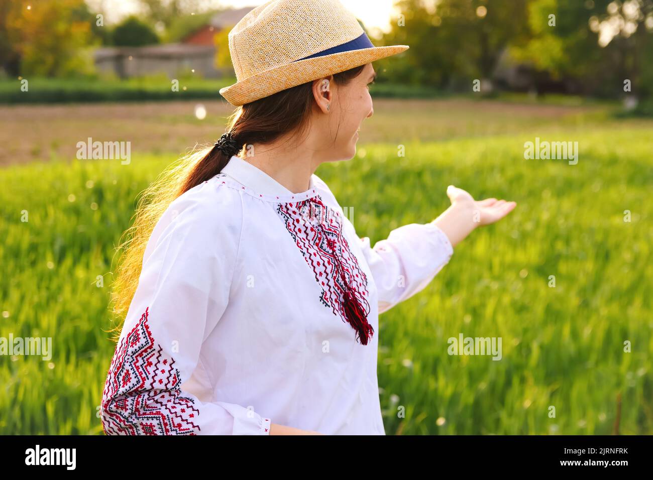 Defocus young ukrainian woman portrait. Meadow nature background. Showing sign love Ukraine ...