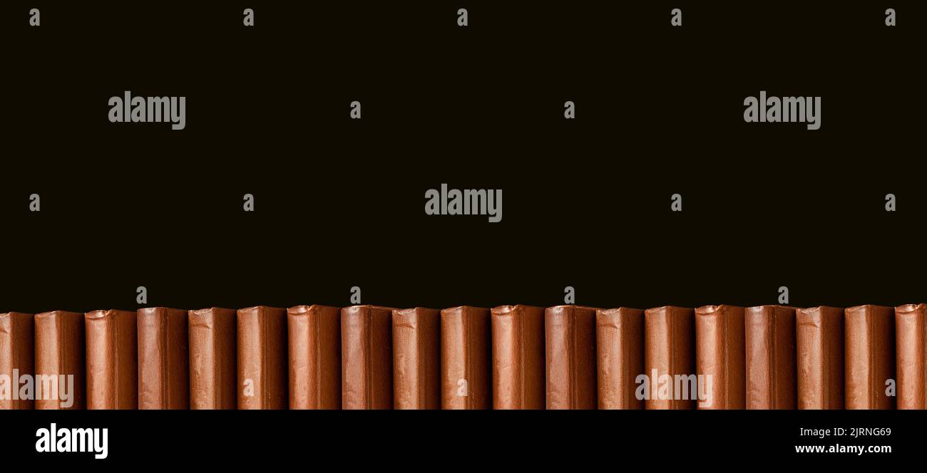 Banner with hardcover brown books row on black background. Horizontal ...
