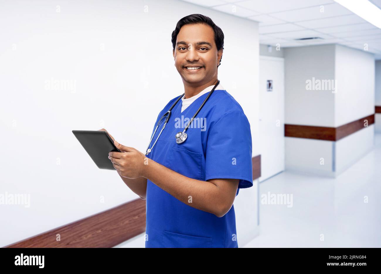 smiling doctor or male nurse using tablet computer Stock Photo - Alamy