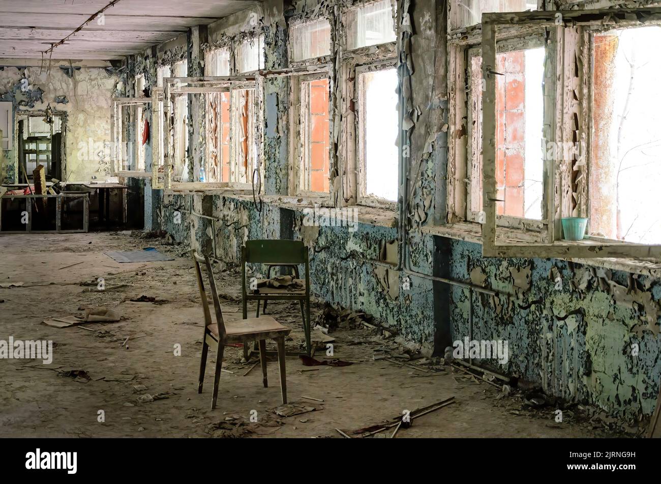 Disintegrating corridor with painting chipping off in a Prypiat ...