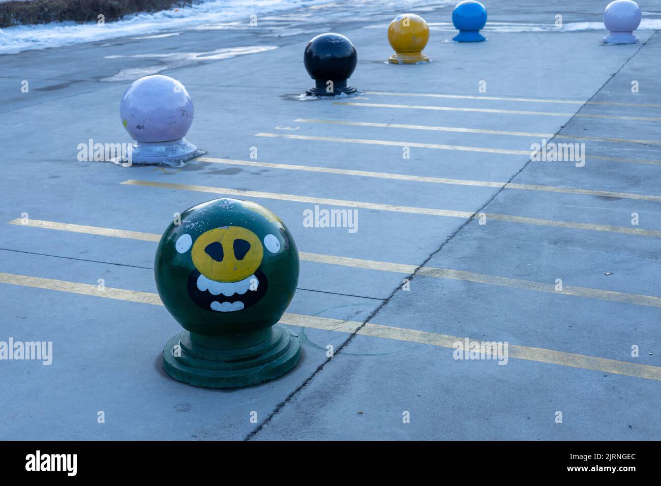 The cute colorful bollards with cartoon faces in the street Stock Photo ...